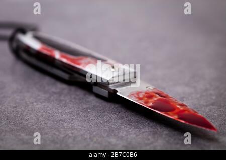 Conceptual image of a sharp knife with blood on it resting on the Stock ...