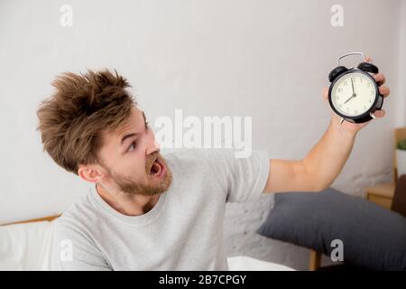 Young employee in time management concept Stock Photo - Alamy