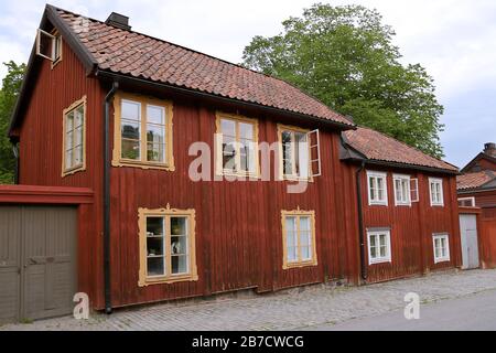 Traditional timber Falun red houses in front of the Aula Medica ...