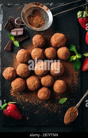 sweet, chocolate truffles and bitter cocoa on a romantic, dark ...