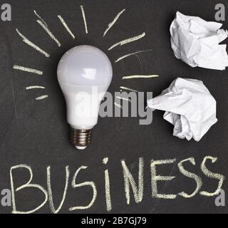 Light bulb on light grey paper background Stock Photo - Alamy
