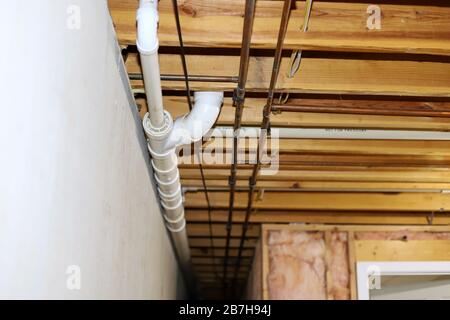 Waste PVC pipe drainage system inside building, piping on the ceiling ...