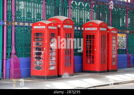 Traditional British red phone booths in a row at Smithfield Market in ...