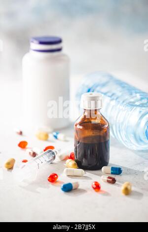 Medical bottles syringe and tablets on light gray background Stock ...