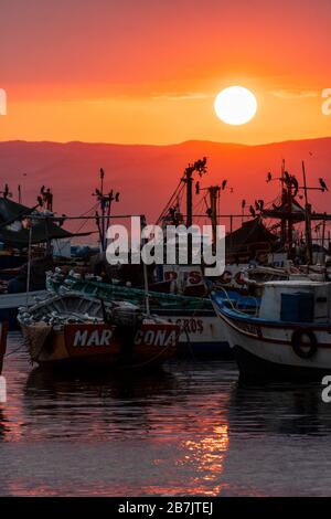 Beautiful colorful sunset at port. Silhouette of docked yachts and ...
