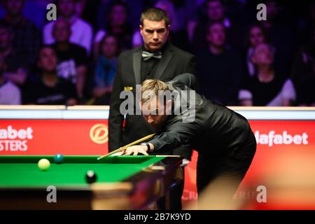 Ali Carter of England, right, plays a shot to Mark Selby of England at ...