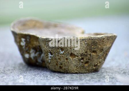 An ancient Chinese silver ingot or sycee of Ming Dynasty is on display ...