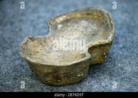 An ancient Chinese silver ingot or sycee of Ming Dynasty is on display ...