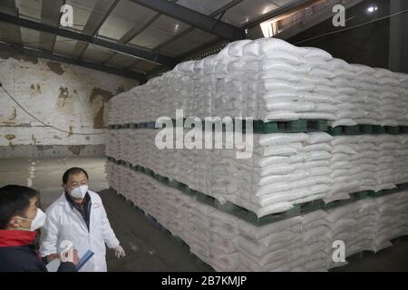 Bags of flour are stored at a warehouse of a flourmill with a long ...