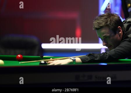 David Gilbert of England plays a shot to Liang Wenbo of China in their ...