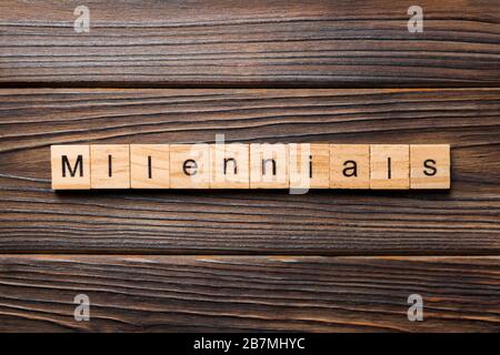 millennials word written on wood block. millennials text on table ...