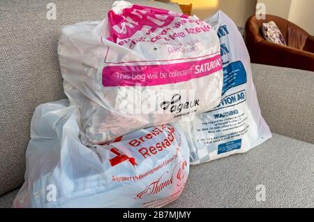 Charity clothing collection bags for donating clothes to different ...