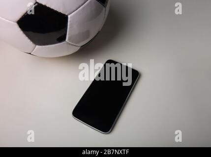 Football ball and money on table Stock Photo - Alamy