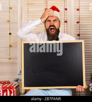 Santa Claus with troubled face with Christmas tree on background Stock ...