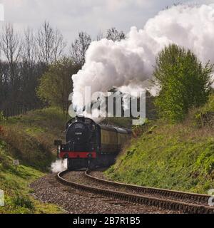 Steam locomotive 53808 pulling a passenger train past the crossing point at Sandhill on the west ...