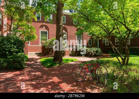 Red brick college dormitory with a bicycle and trees Stock Photo - Alamy