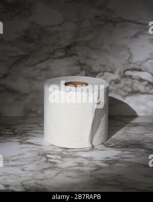 Toilet paper supply. Roll on gray background Stock Photo - Alamy