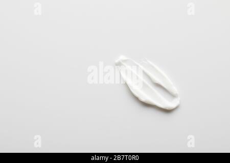 Top view of cosmetic cream brushstroke on grey background Stock Photo ...