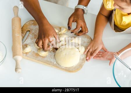 Kid hands cooking dumplings with raw salmon on the kitchen. Stay at ...
