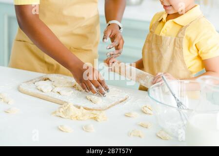 Kid hands cooking dumplings with raw salmon on the kitchen. Stay at ...