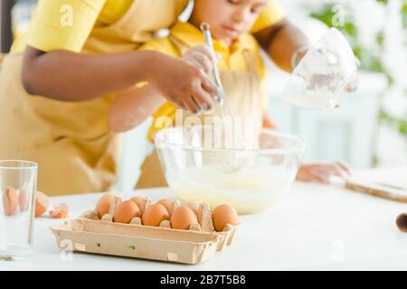 Ingredients in glass mixing bowls to prepare spinach and ham frittata ...