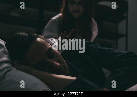 Scary woman possessed by devil in the bed. Exorcism of priest. Woman ...
