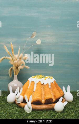 Vase with willow branches and wooden bunny on table Stock Photo - Alamy