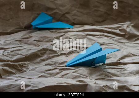 Blue paper planes on beige background Stock Photo - Alamy