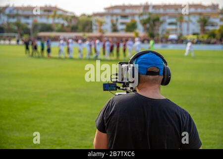 A TV camera and cameraman on a running track in a stadium in Komazawa ...