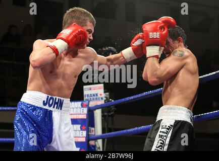 John Wayne Hibbert (blue/white shorts) defeats Andrew Patterson in a Light-Middleweight boxing ...