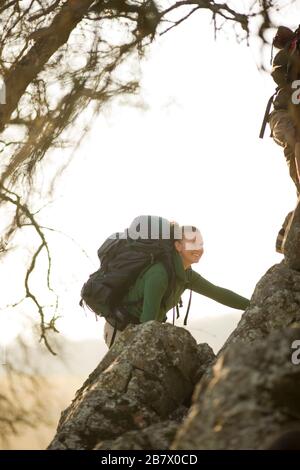 Happy young woman hiking Stock Photo - Alamy