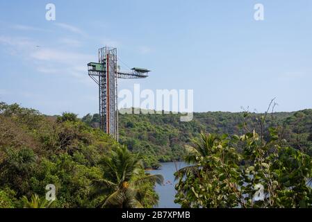 Landscape image of Mayem Lake in Goa with the bungee jumping structure ...