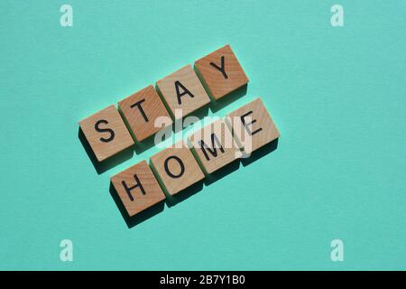 Stay Home, words in 3d wood alphabet letters on red background Stock ...