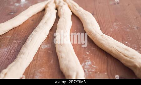 Step by step. Brading dough to bake fresh challah bread Stock Photo - Alamy