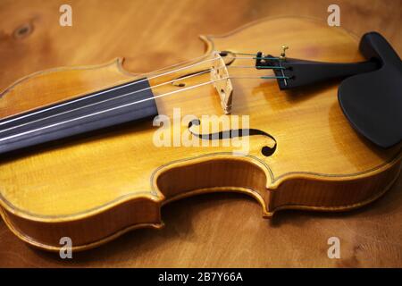 A wooden violin (musical instrument) lies on the table Stock Photo - Alamy