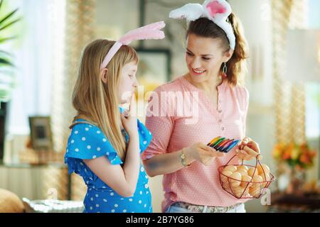 mother with child coloring easter eggs at home Stock Photo - Alamy