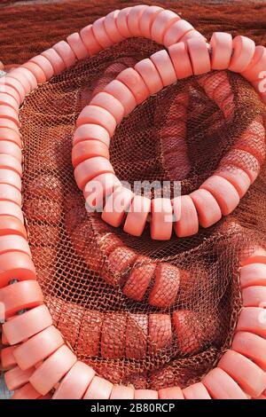 Fishing nets and buoys in storage racks Stock Photo - Alamy