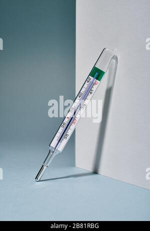 old medical mercury thermometer and paper case on black grunge wooden ...