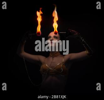 Woman performing fire spinning in a graffiti-covered urban setting. WA ...