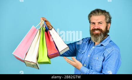 Delighted man shopping online. Extremely happy hipster making purchases ...