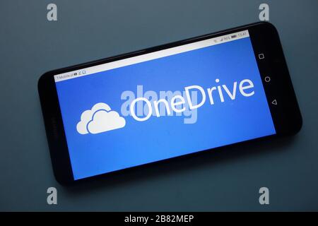 Microsoft OneDrive website displayed on smartphone hidden in jeans ...