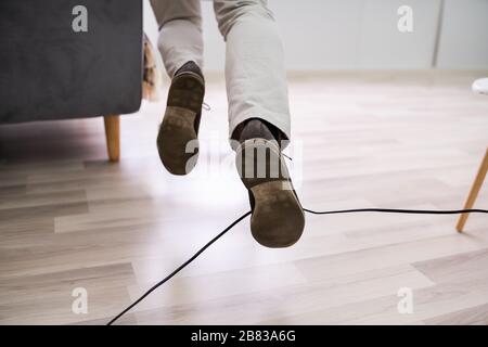 Close-up Of A Man Legs Stumbling With An Electrical Cord At Home Stock ...