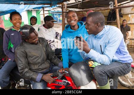 Young motorcyclist hanging out at Boda boda stand, Mathare, Nairobi ...