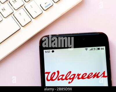 In this photo illustration, the Walgreens logo is seen displayed on a ...
