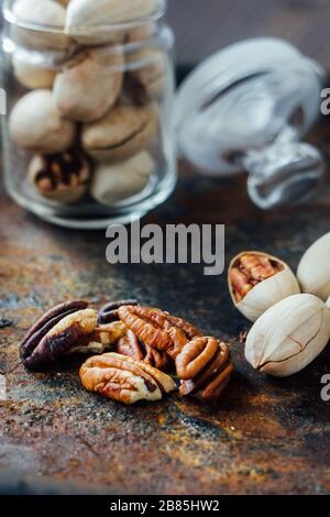 Pecan nuts inside glass jar on rustic surface Stock Photo - Alamy