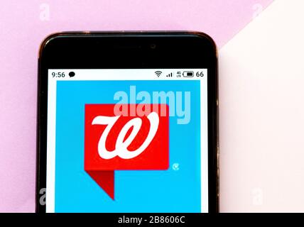In this photo illustration, a Walgreens logo is seen displayed on a ...