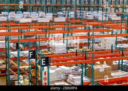 Warehouse interior with metal racks full of merchandise. Wholesale ...