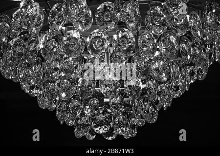 A closeup of illuminated crystal chandelier on black background Stock ...