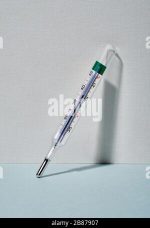 old medical mercury thermometer and paper case on black grunge wooden ...