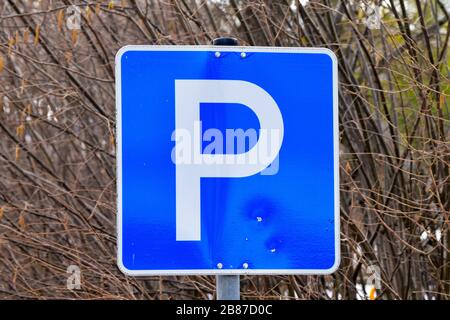 A square parking sign with a white letter p set on a blue background ...